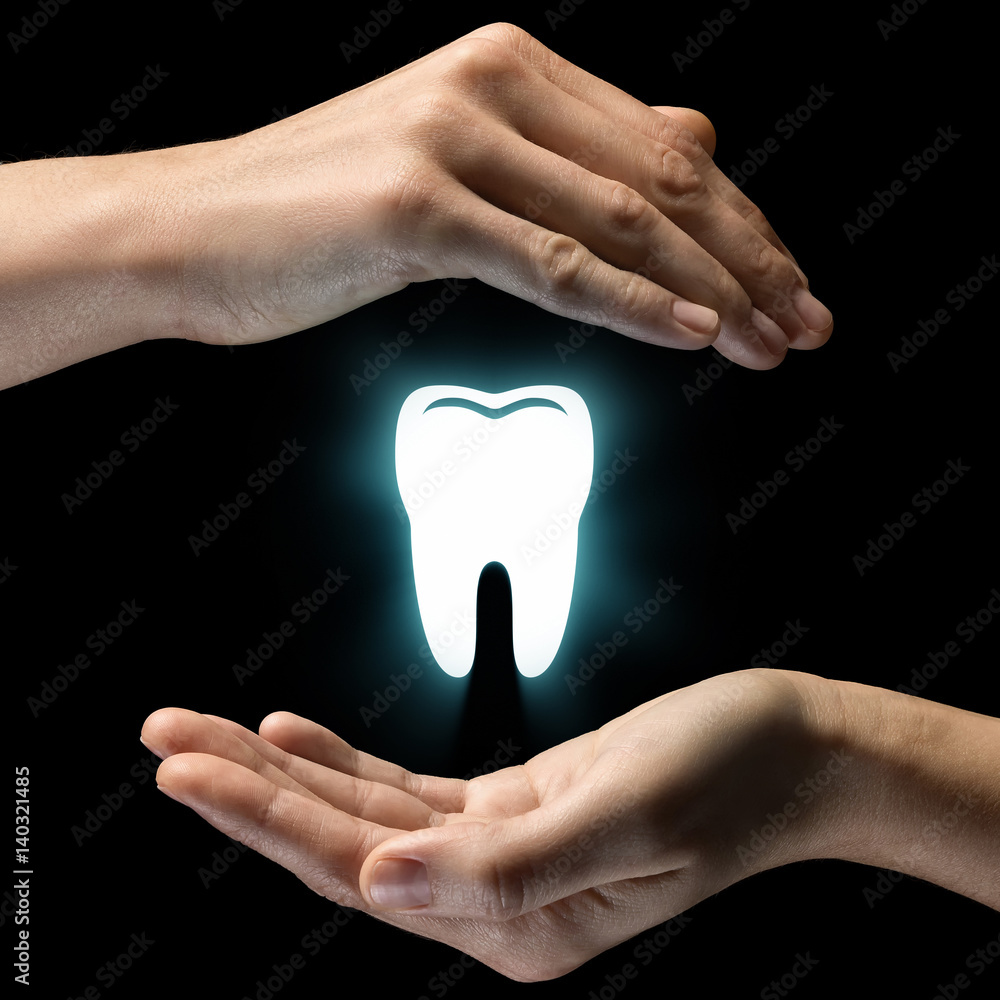 Isolated image of two hands on black background. Tooth icon in the ...