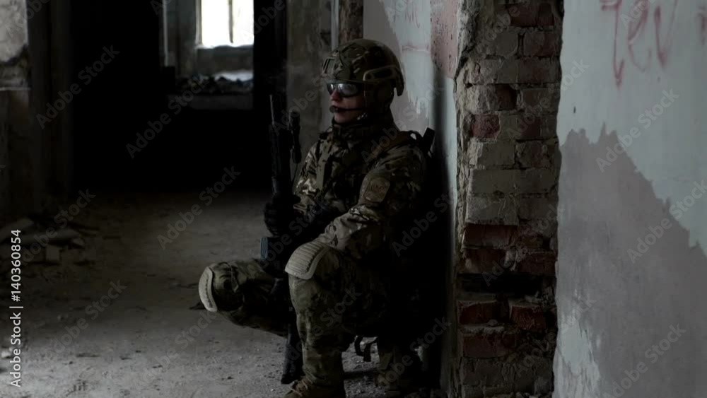 A military man with a weapon is ambushed in an abandoned building Stock ...