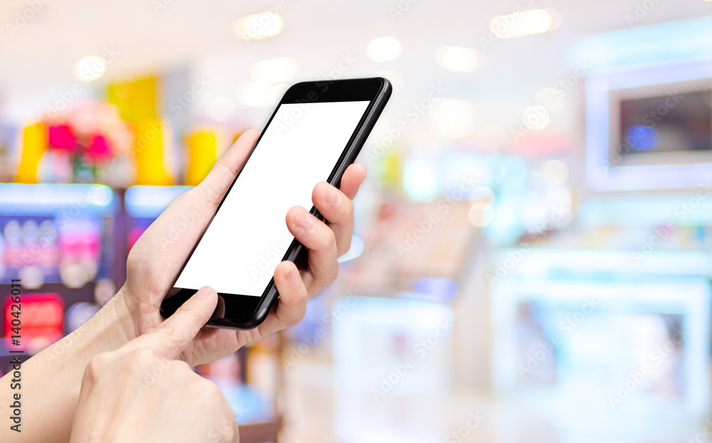 Hand click mobile phone with blur department store background bokeh ...