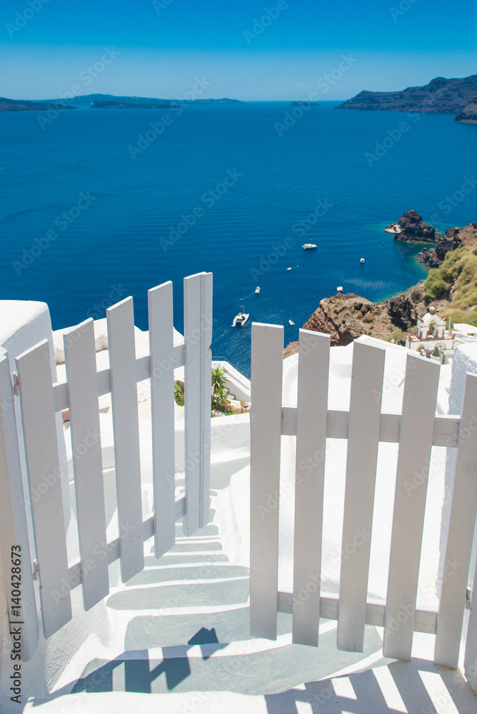 White fence, entrance gate to the hotel.Architecture of island of ...