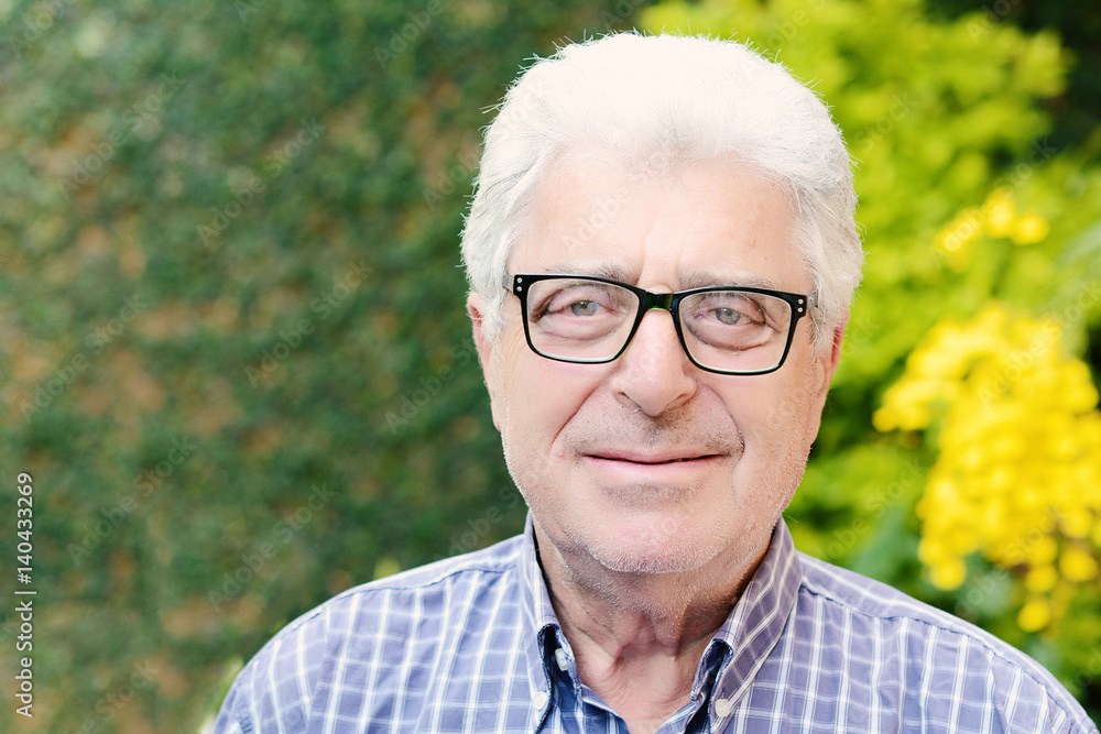 An old man sitting outside. Stock Photo | Adobe Stock