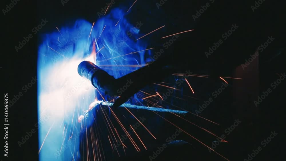 Welding on an industrial plant. Industrial Robot arm active in factory ...