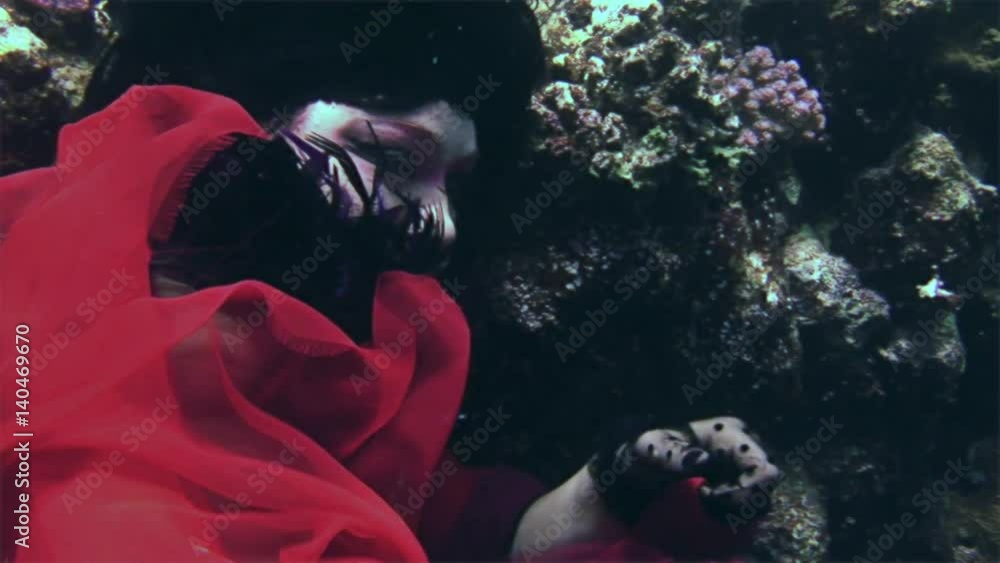 Young girl model free diver underwater in red costume of pirate in Red ...