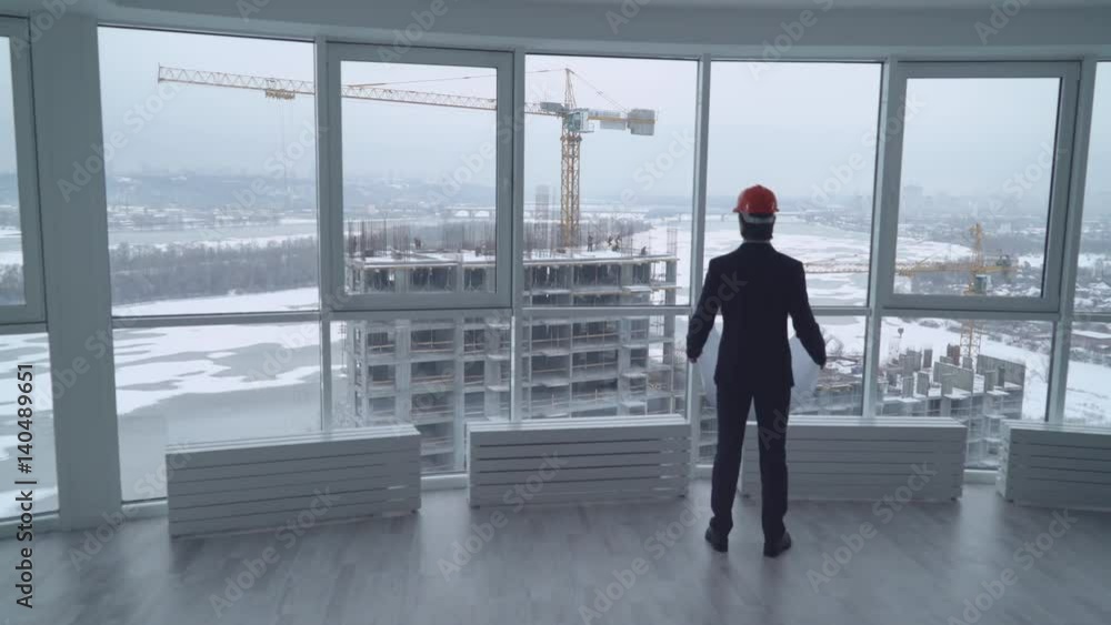 Vidéo Stock engineer architect looking on the plan. rear back view man ...