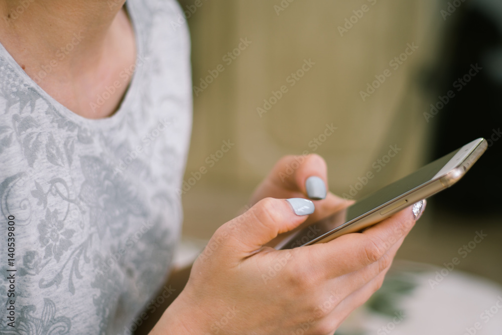 Beautiful girl holding a smartphone in the hands of a green screen ...
