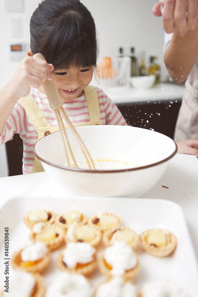 Mother and daughter making dessert Stock Photo | Adobe Stock