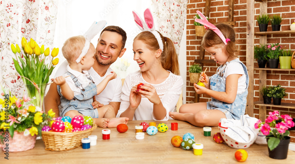 Happy easter! family mother, father and children paint eggs for holiday ...