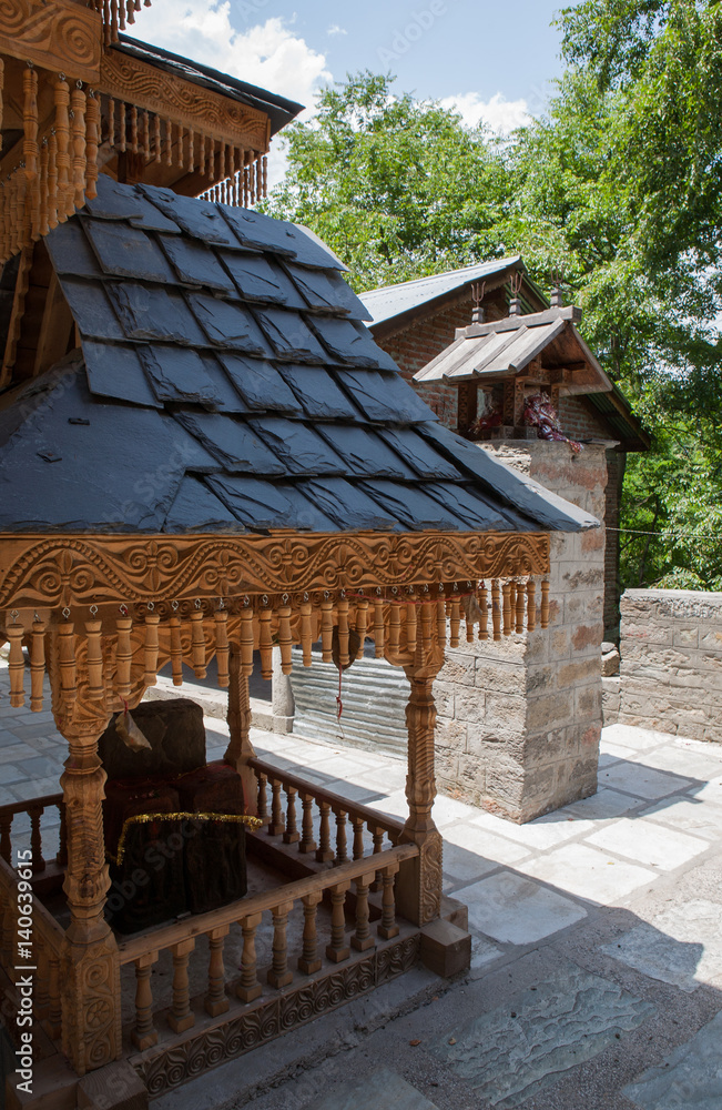 MANALI, INDIA. A small Shiva Temple decorated with wood-carved a ...