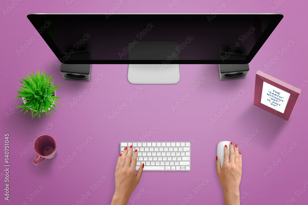 Top view work desk scene with computer display, keyboard, and mouse. Woman typing and use mouse ...