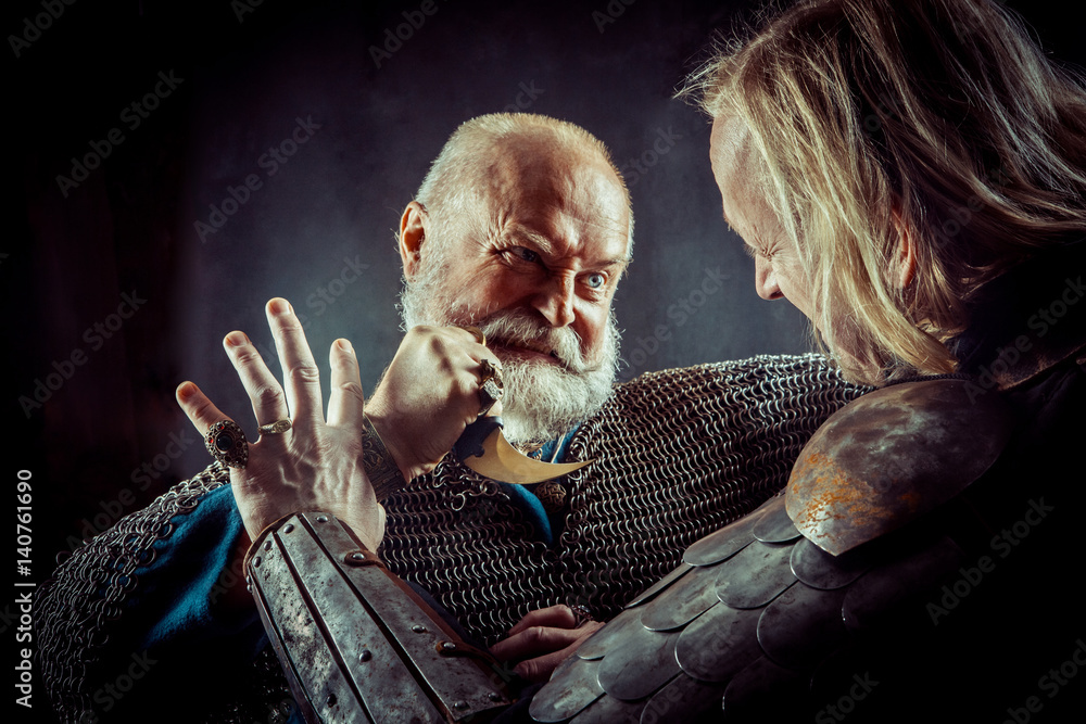 Dagger fight between two medieval knights on the dark background Stock ...