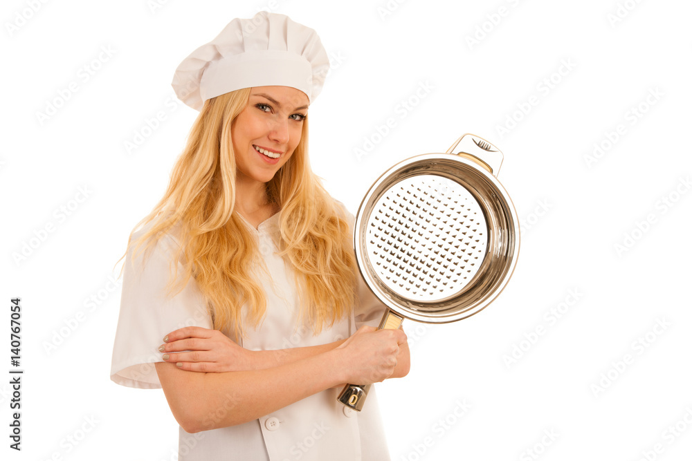 young blonde chef woamn holds kitchenware as she prepares to cook a ...