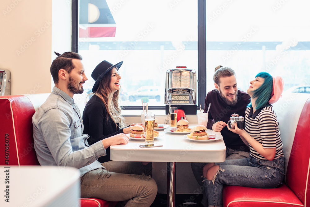 Friends Enjoying Fun Time at Fast Food Restaurant Stock Photo | Adobe Stock