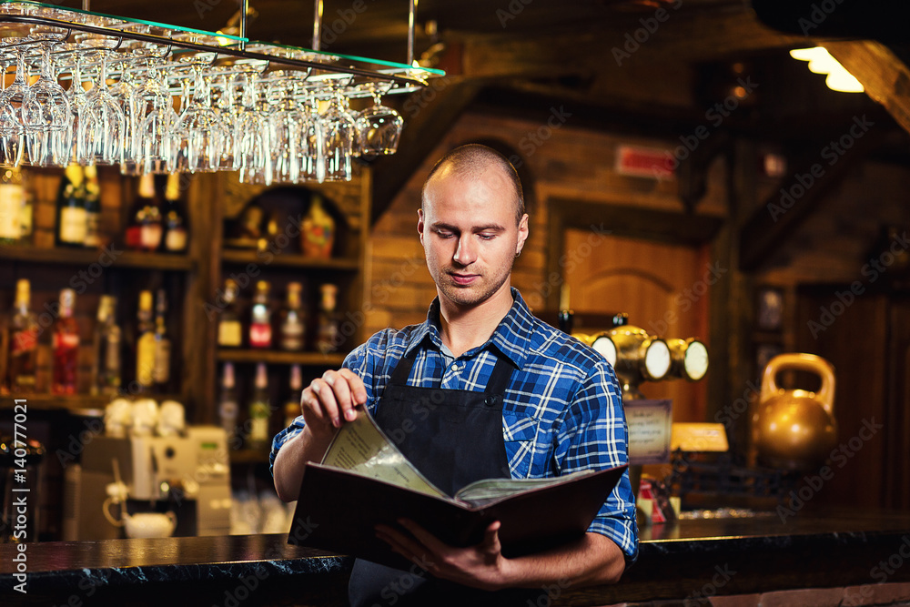 Barman at work in pub,Portrait of cheerful barman worker standing ...