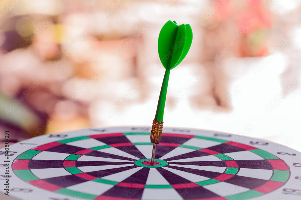 green dart on dart board with clor background Stock Photo | Adobe Stock