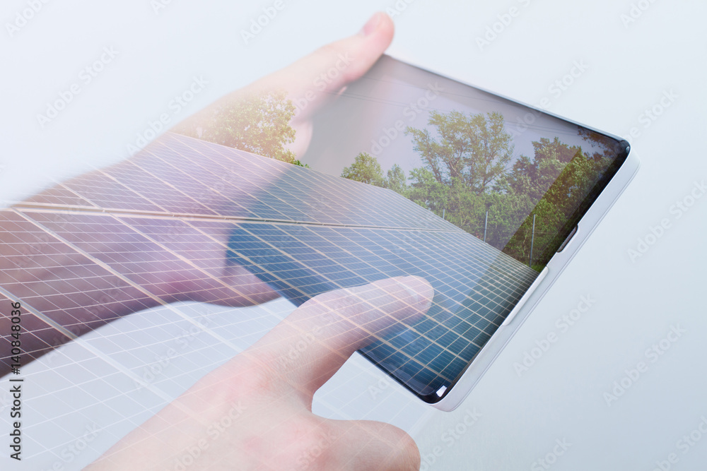 double exposure, hand holding digital tablet, solar panels on screen ...