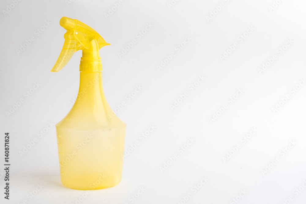 Small liquid atomizer of different colors on a white background, yellow ...