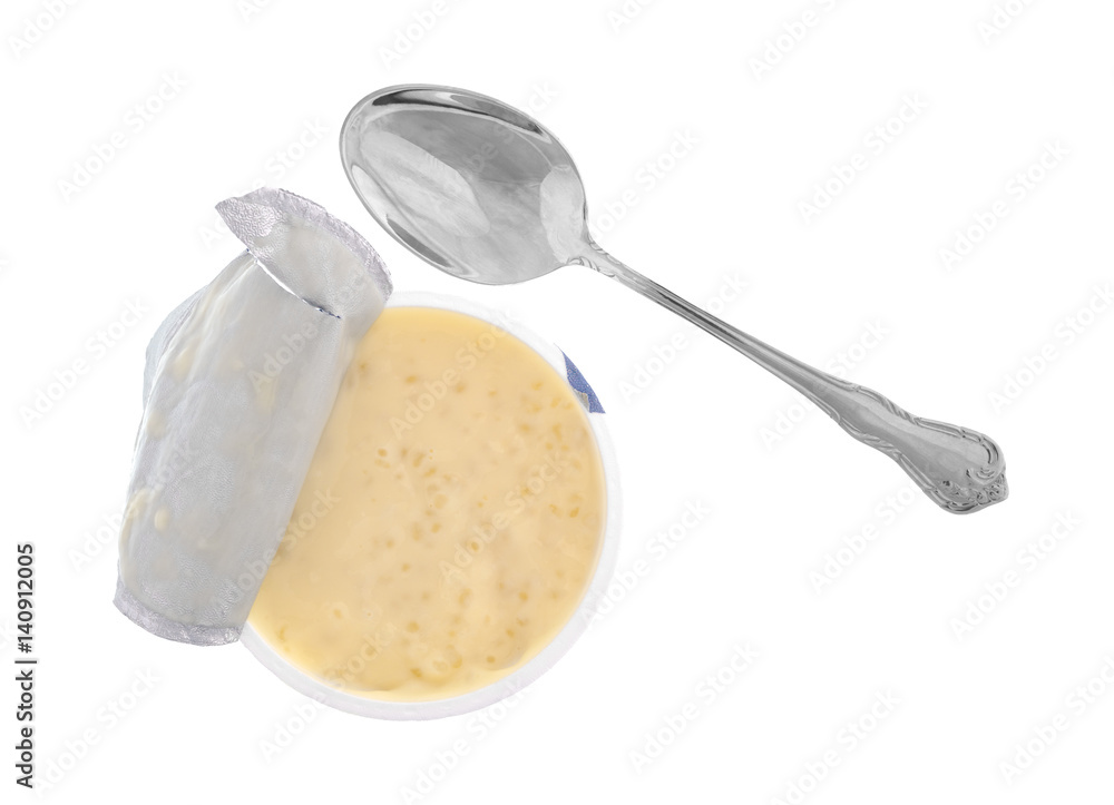 Tapioca pudding in a container with a spoon to the side and the tinfoil ...