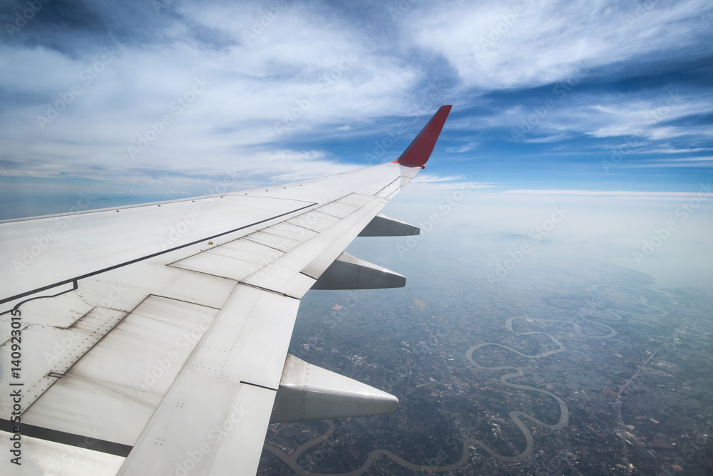 Clouds and sky as seen through window of an aircraft. Looking through ...