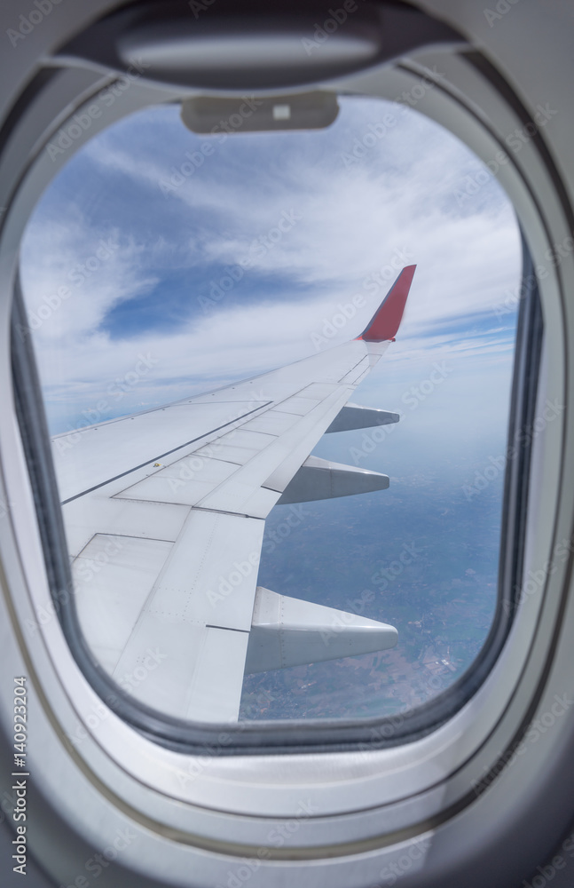 Clouds and sky as seen through window of an aircraft. Looking through ...