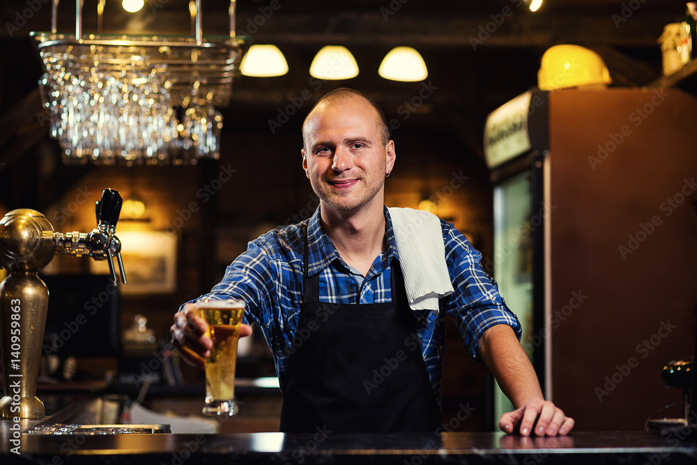 Bartender pouring the fresh beer in pub,barman hand at beer tap pouring ...