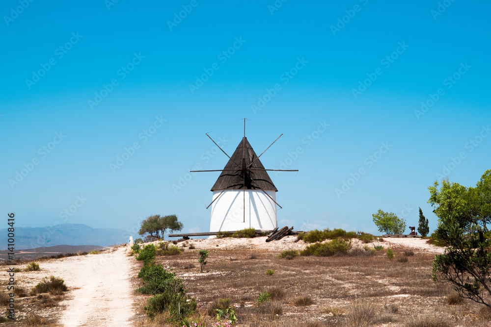 Old white windmill on a southern spanish field Stock Photo | Adobe Stock