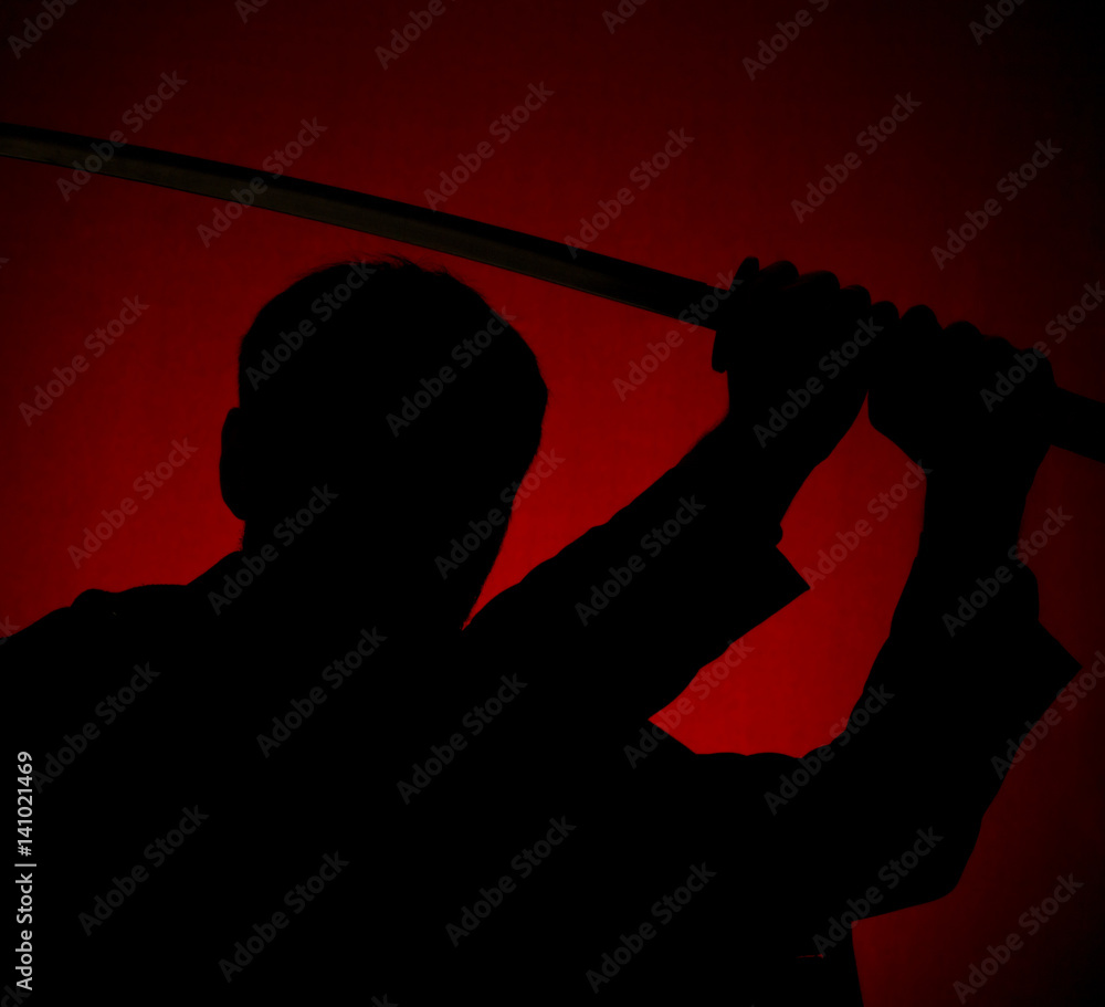 Silhouette of man with sword on red background Stock Photo | Adobe Stock