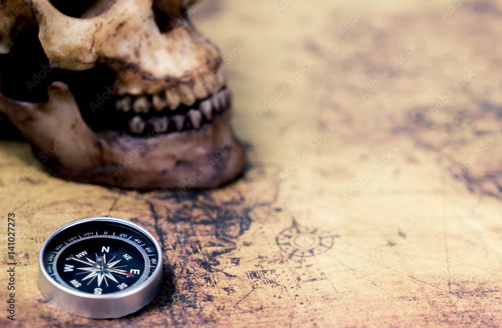 Compass and Dead Skull on vintage map for treasure hunter concept with ...