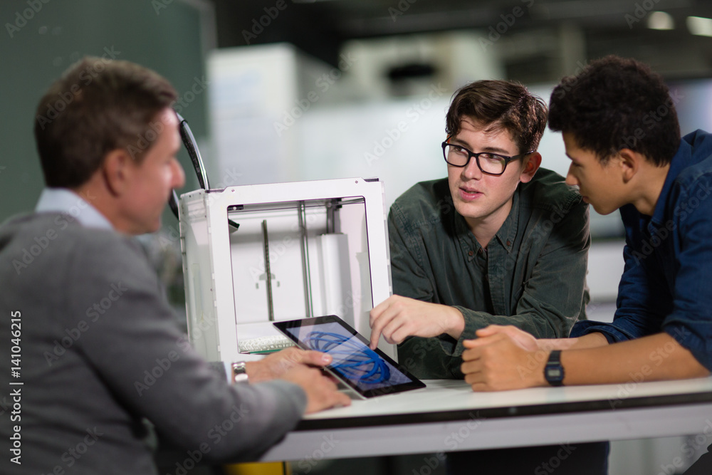 Students looking at a design for 3d model Stock Photo | Adobe Stock
