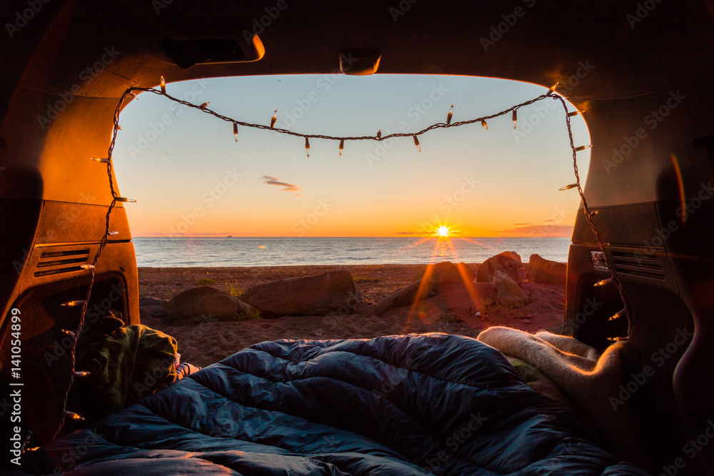 Sunset over water, viewed from inside of vehicle Stock Photo | Adobe Stock