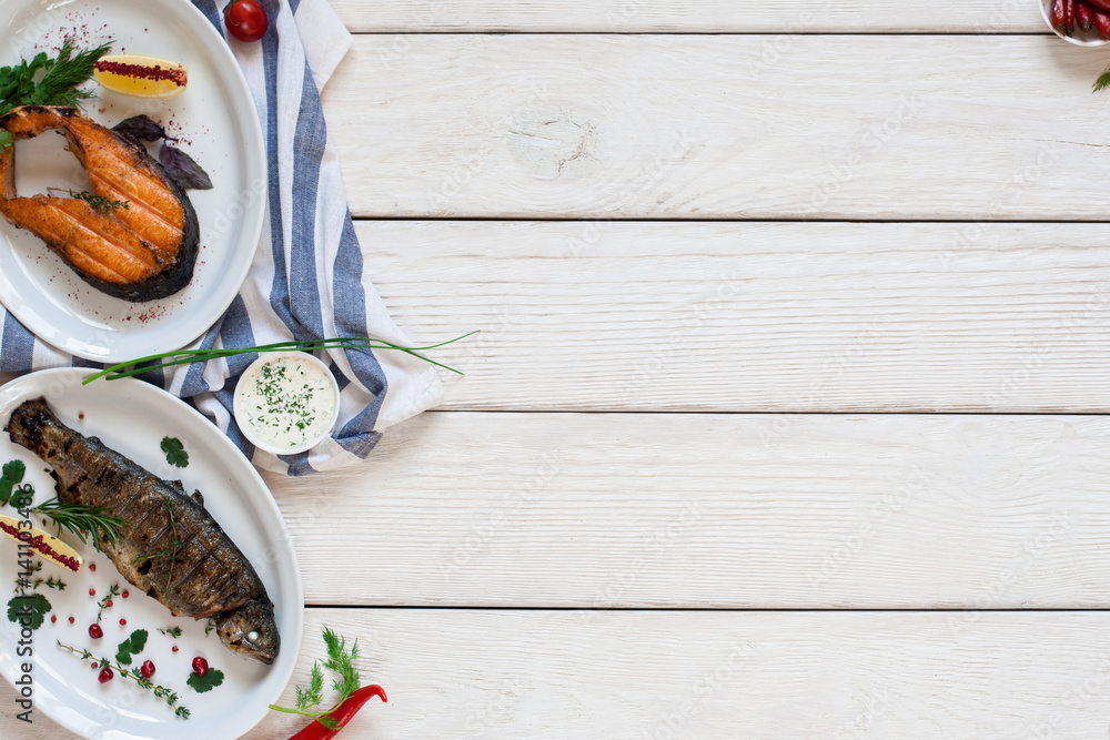 Grilled fish on white wood free space. Top view on empty wooden table ...
