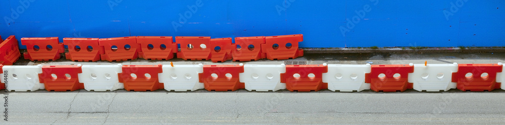 Orange and white interlocking construction barrier. Stock Photo | Adobe ...
