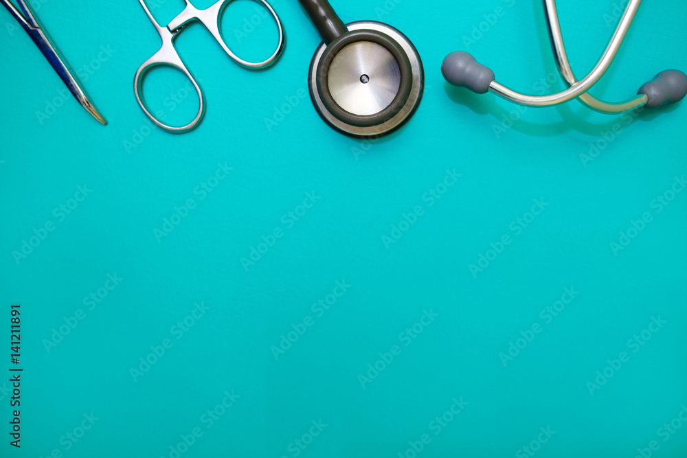 Medical green background with stethoscope and forceps. Stock Photo ...