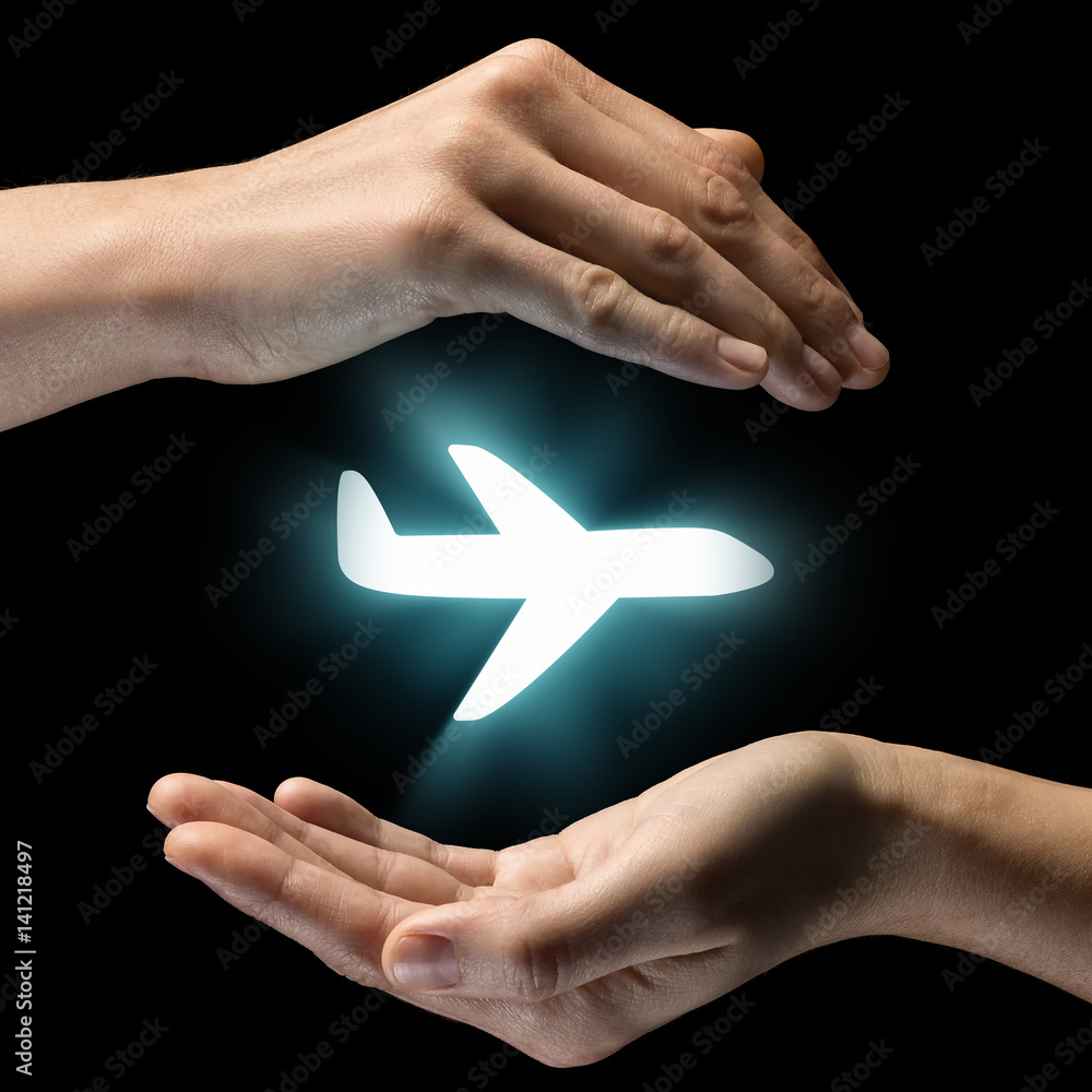 Isolated image of two hands on black background. Plane icon in the ...