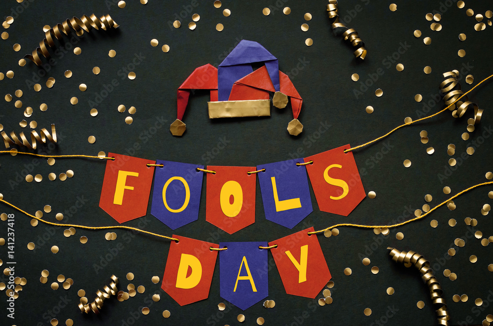 Fools day letters on handmade paper colorful holiday garland, folded ...