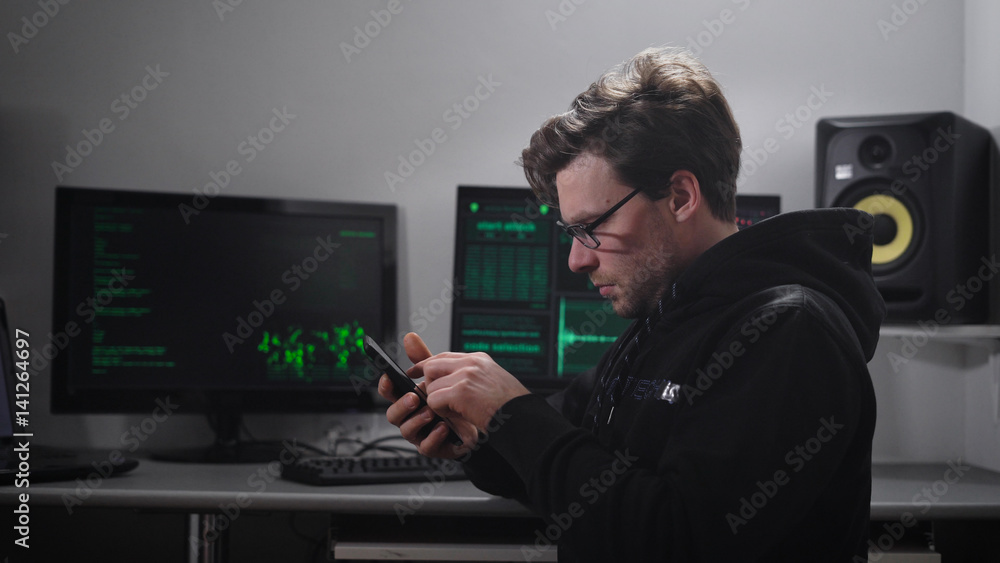 Adult serious man, looking like Hacker, with a small stubble on the ...