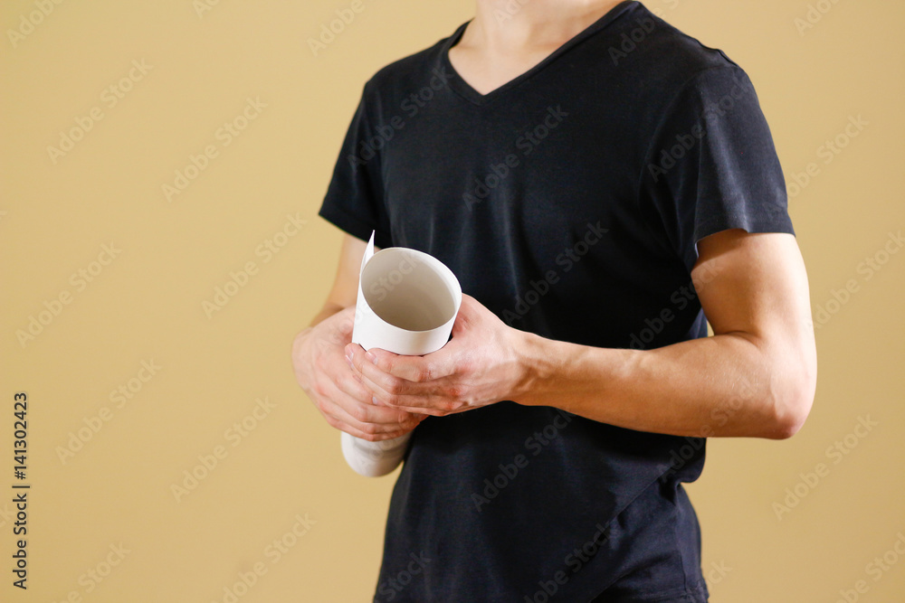 Guy holds in his hands twisted up in paper. Opens the package of paper ...