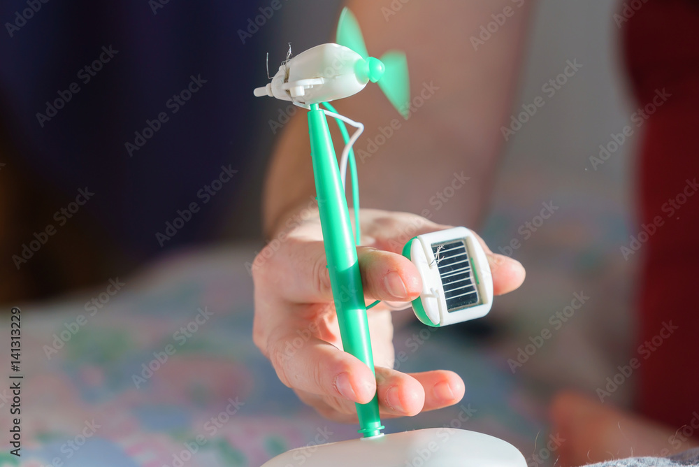 boy with solar panel windmill Stock Photo | Adobe Stock