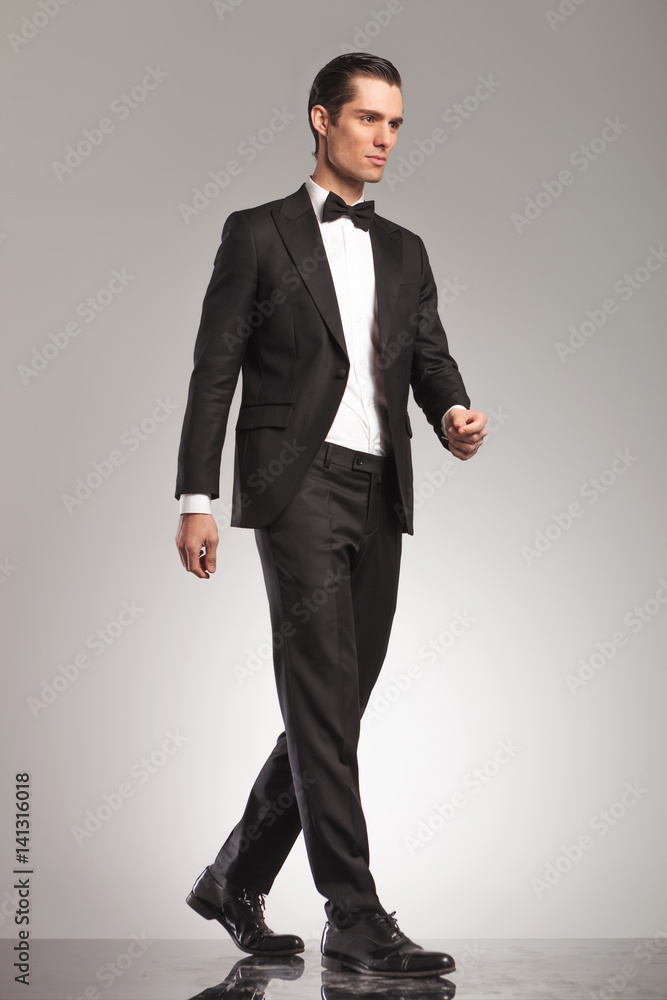 full body picture of an elegant man in tuxedo walking Stock Photo ...
