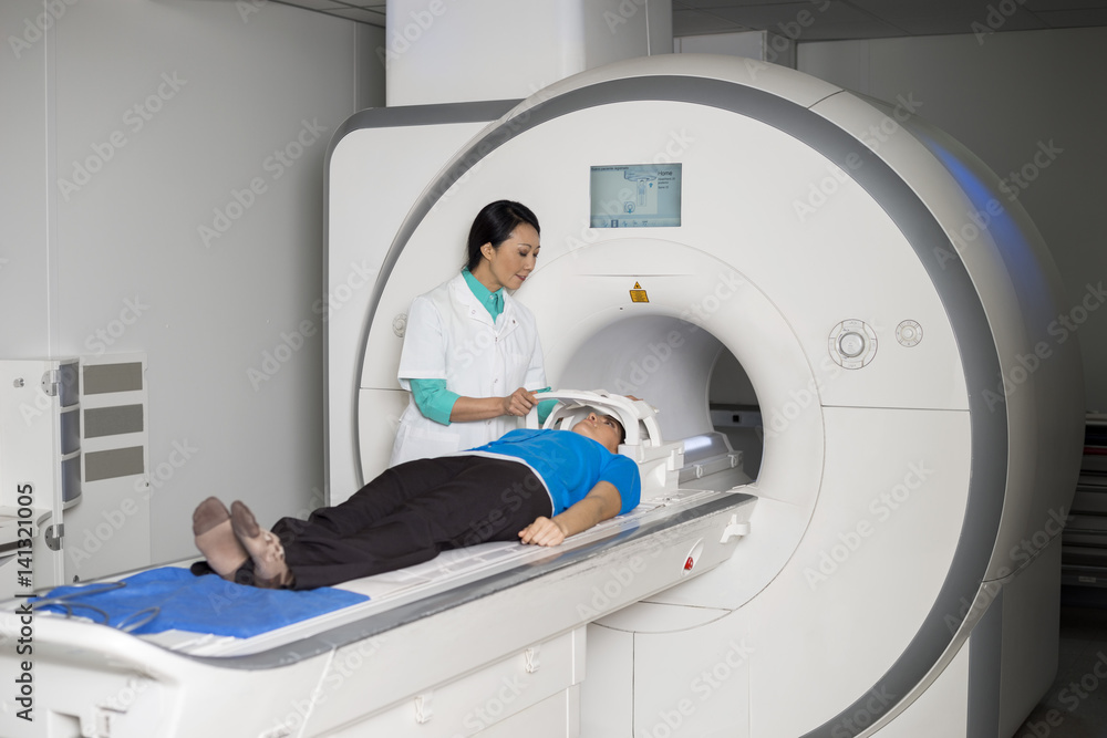 Doctor Fixing Mask To Patient Lying On CT Scan Machine Stock Photo ...