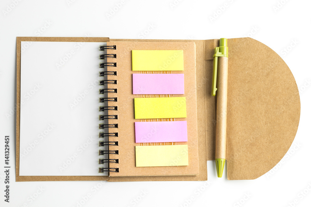 Notebook paper and a pen on white background. Stock Photo | Adobe Stock