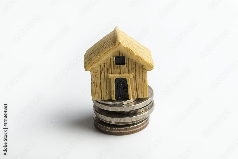 Toy house on coins. Stock Photo | Adobe Stock