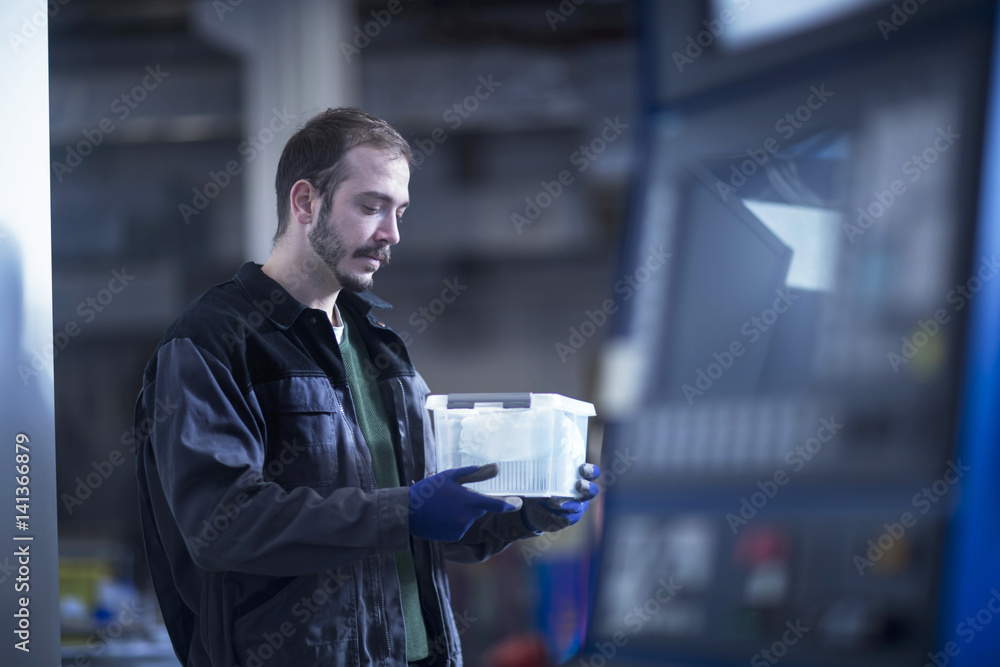 Engineer carrying plastic storage box Stock Photo | Adobe Stock