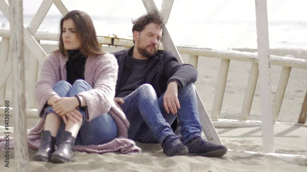 Angry couple fighting sitting on sand on the beach Stock Video | Adobe ...