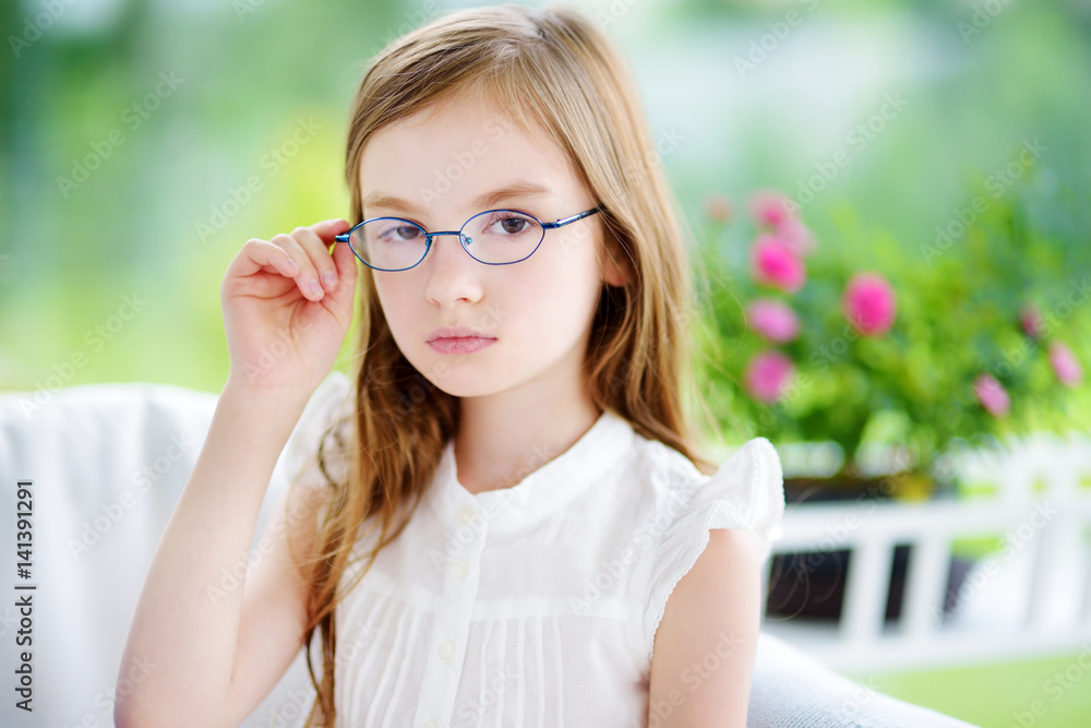 Portrait of cute little girl wearing glasses at home. Vision, health ...