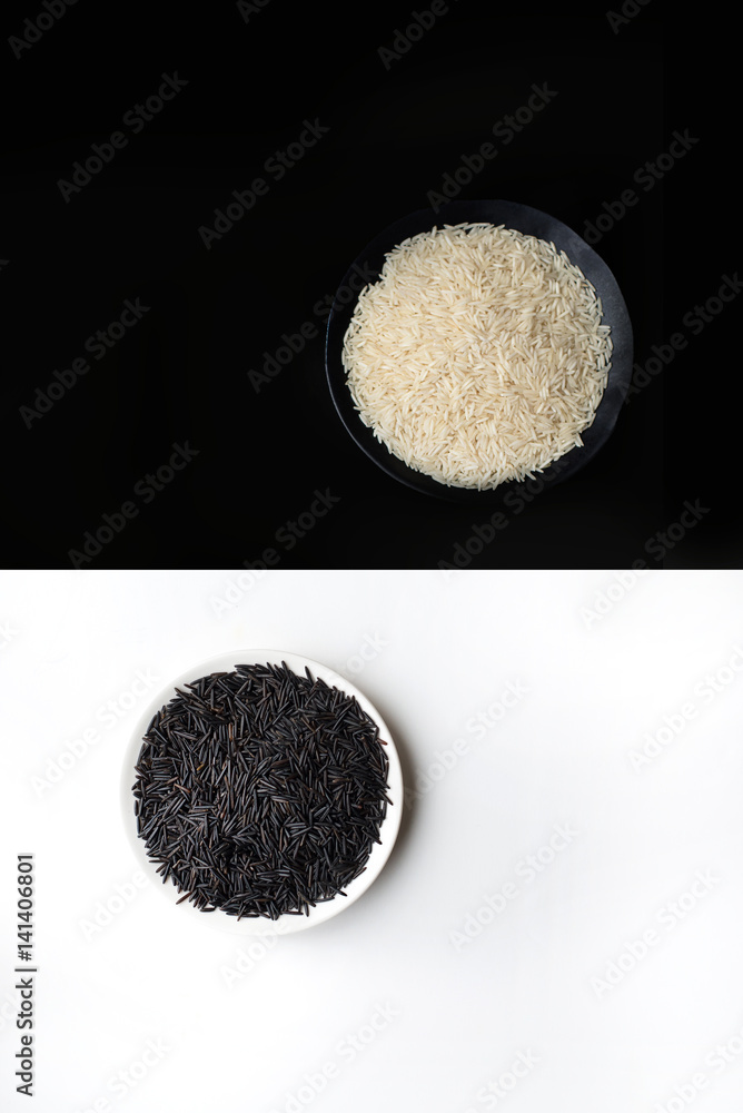 Still life of bowls of black and white rice on opposing black and white ...