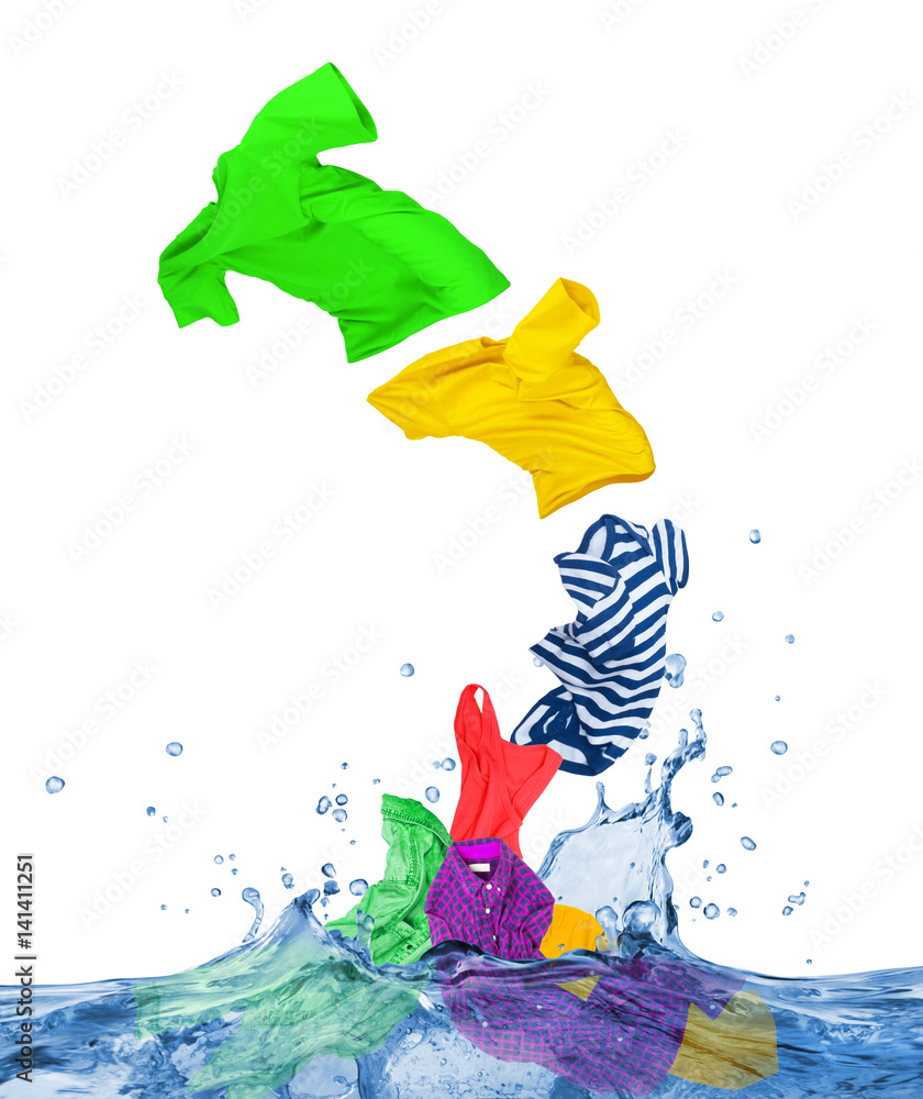 Colorful clothes fly out of the water, isolated on white background ...