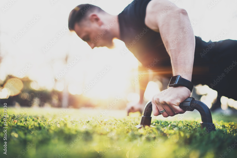 Workout lifestyle concept.Muscular athlete exercising push up outside ...