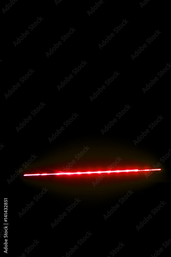 Laser beam red on a black background Stock Photo | Adobe Stock