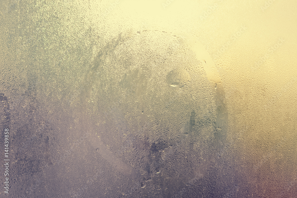 Happy smile drawn on the fogged glass window background. Close up image ...