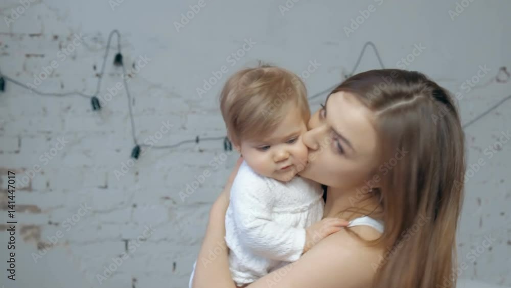 Mother with her newborn baby. Mother is holding her little baby girl ...